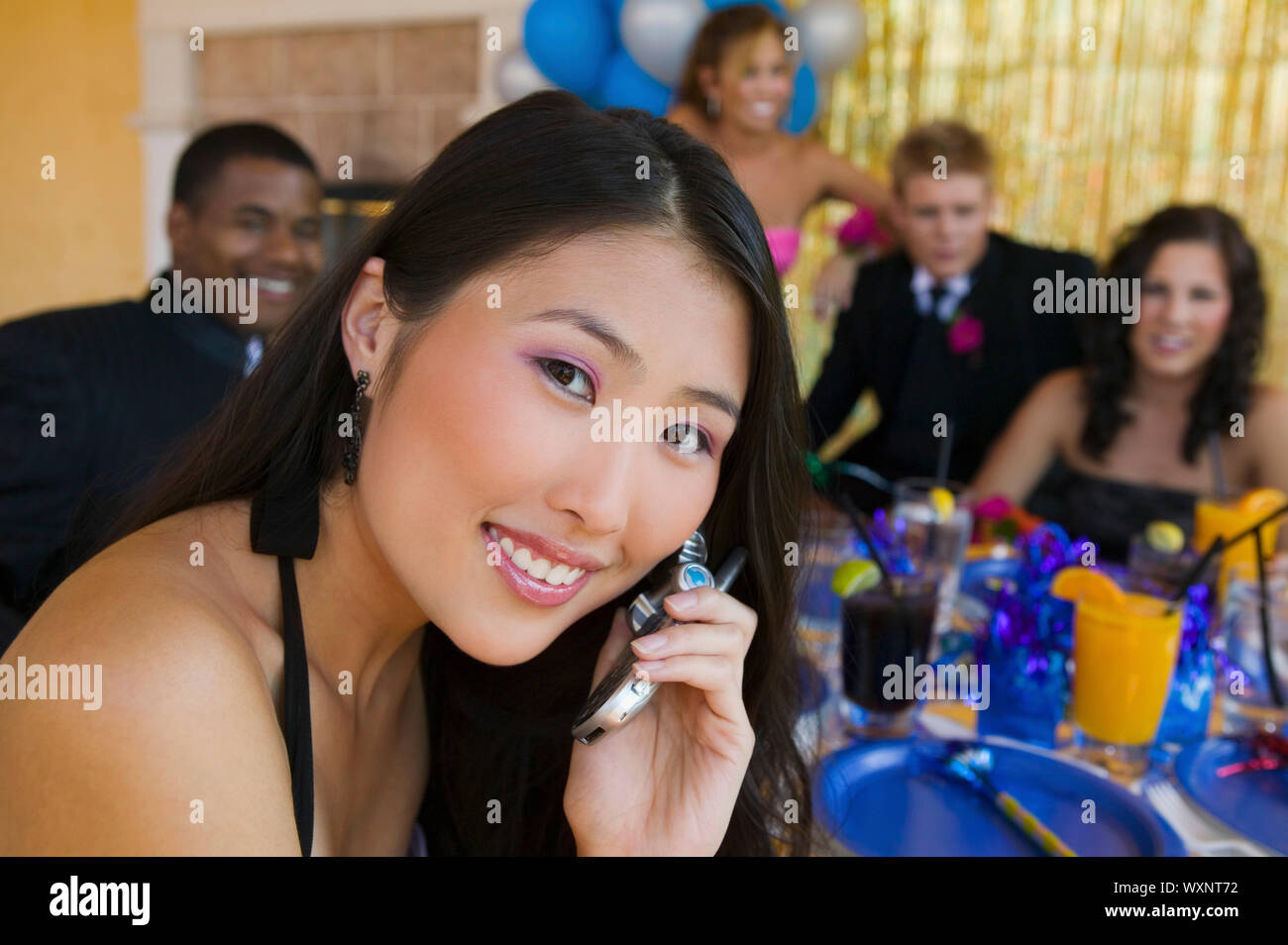 Teenage Girl at Party Using Cell Phone Stock Photo - Alamy