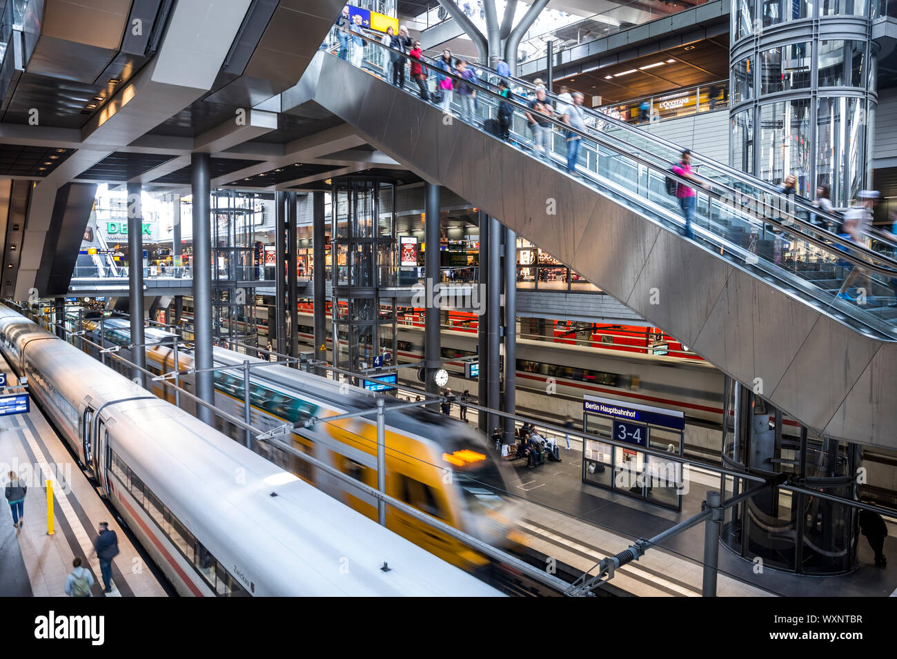 Passengers, and a train arriving at a platform inside the main train ...