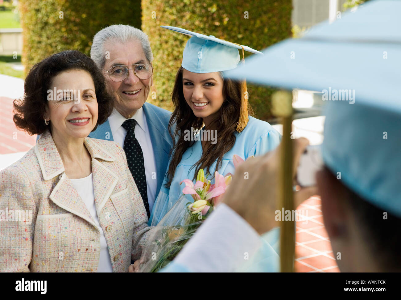 Graduate Posing for Picture with Parents Stock Photo - Alamy