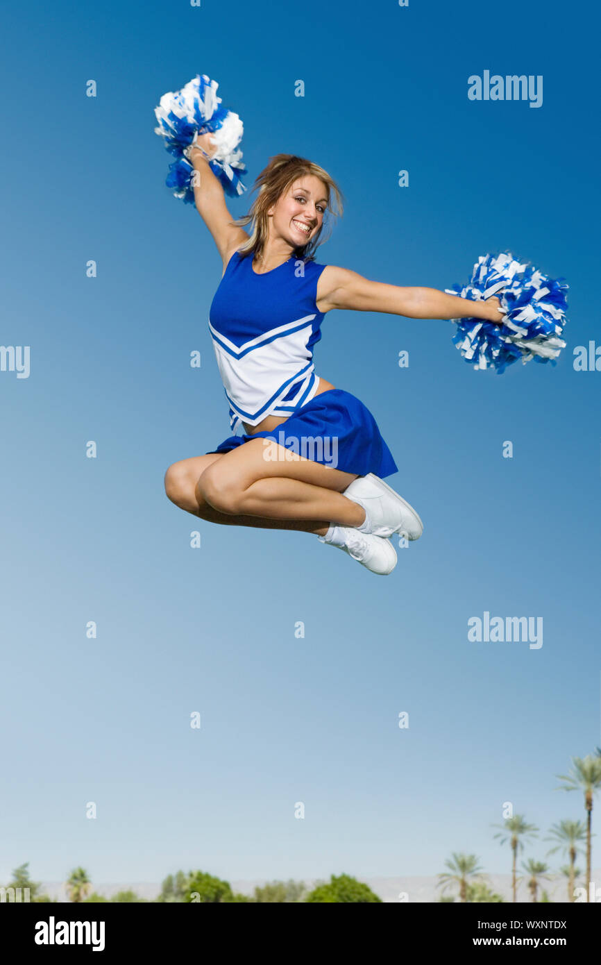 Cheerleader Performing Cheer in Mid-Air Stock Photo - Alamy