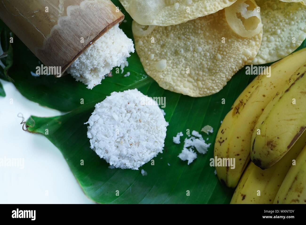 Kerala breakfast white rice puttu made in bamboo mould with Papad and ...