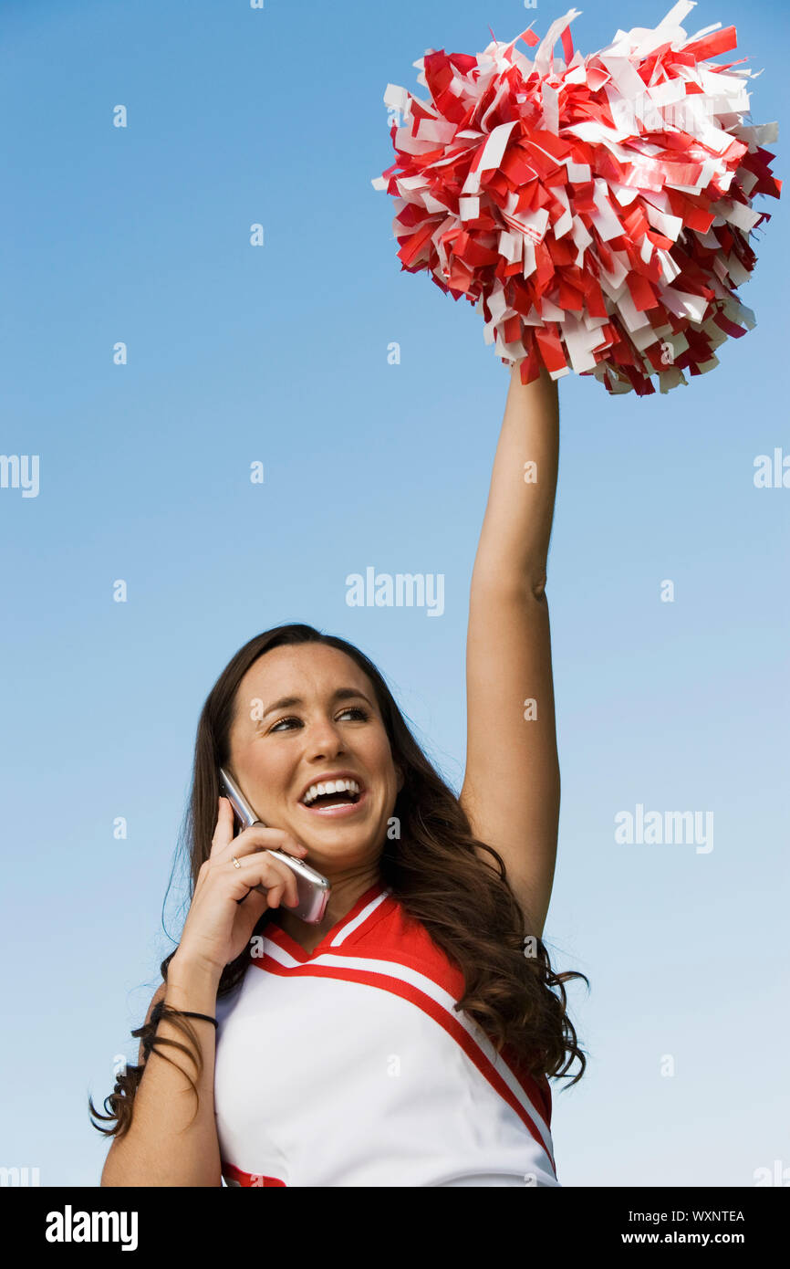 Cheerleader Using Cell Phone Stock Photo - Alamy