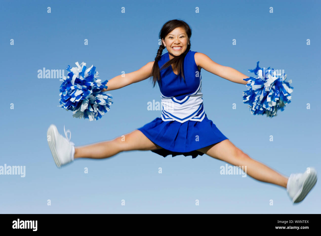 Cheerleader Performing Cheer in Mid-Air Stock Photo - Alamy