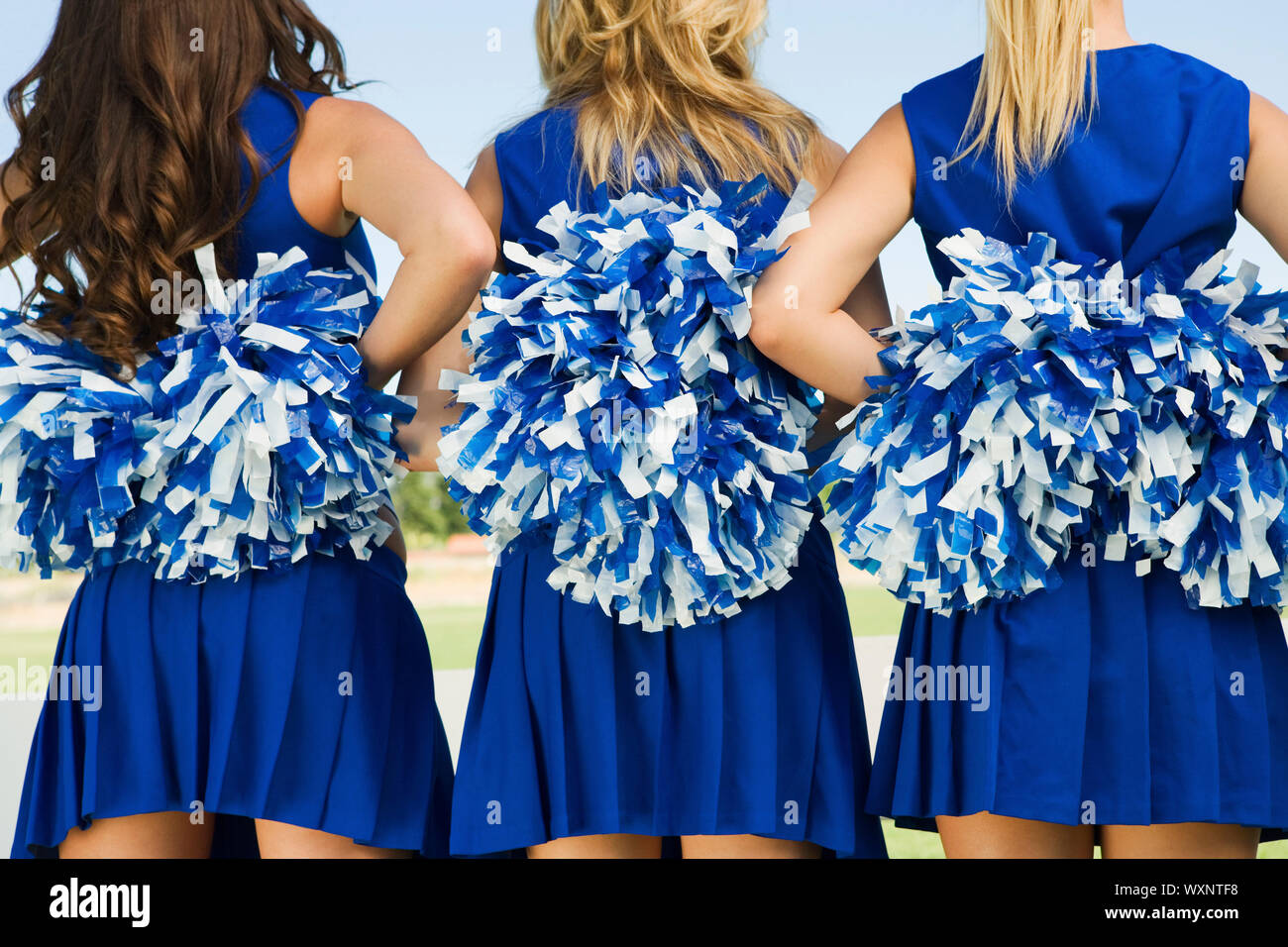 Three Cheerleaders in a Row Stock Photo - Alamy