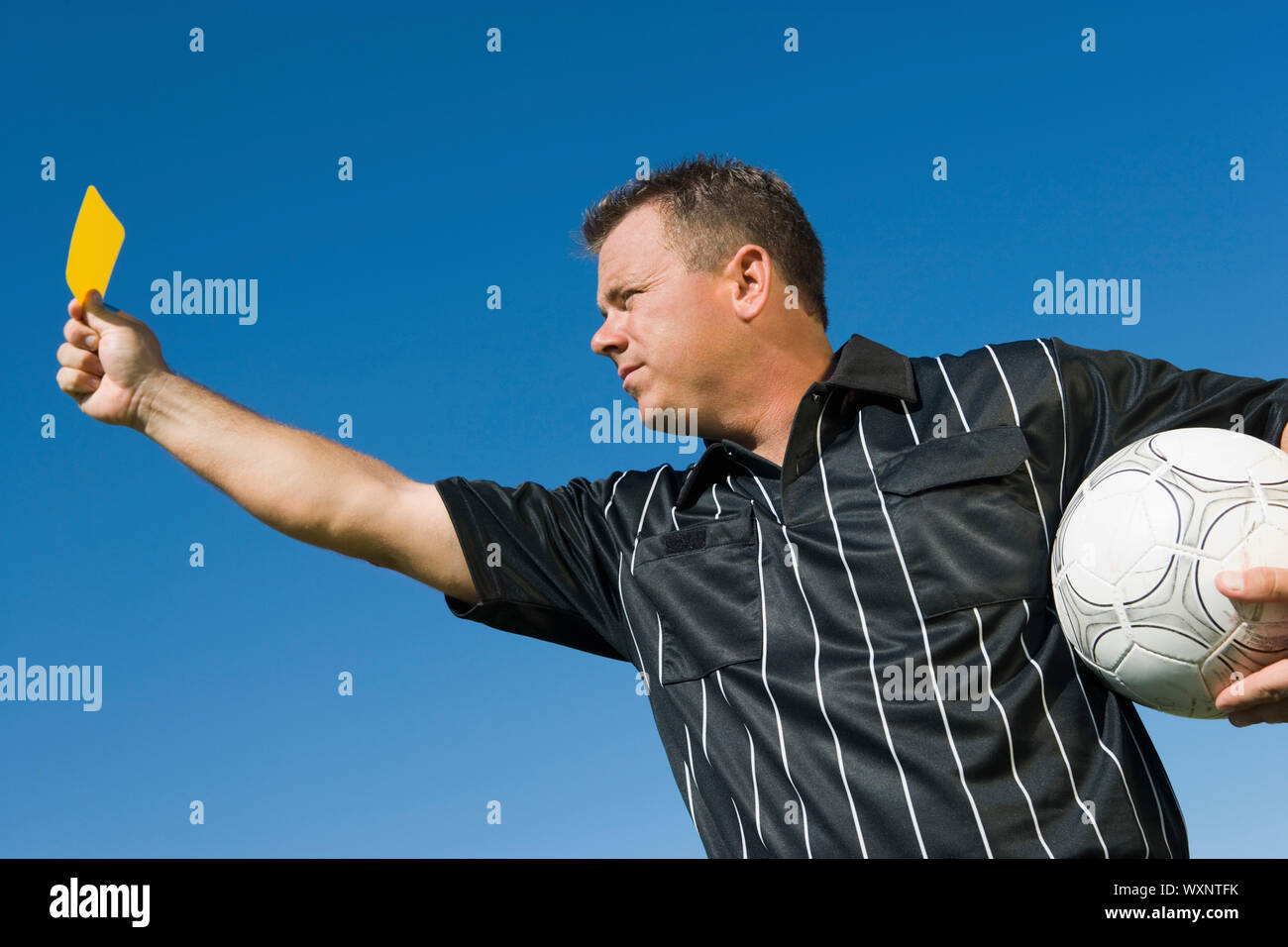 Soccer Referee Holding Yellow Card Stock Photo - Alamy