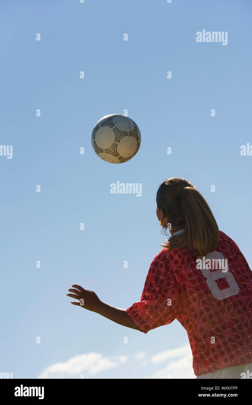 Teenage Girl Heading Soccer Ball Stock Photo - Alamy