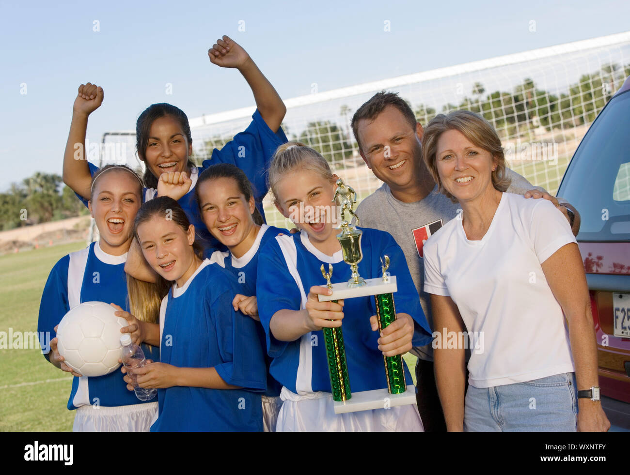 Parents with Daughter's Soccer Team and Trophy Stock Photo - Alamy