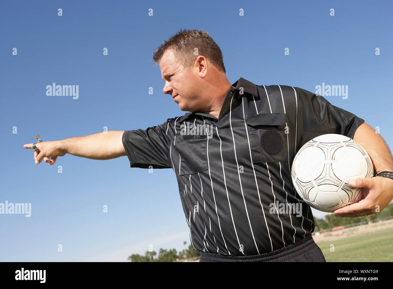 Referee With Soccer Ball Pointing Stock Photo - Alamy