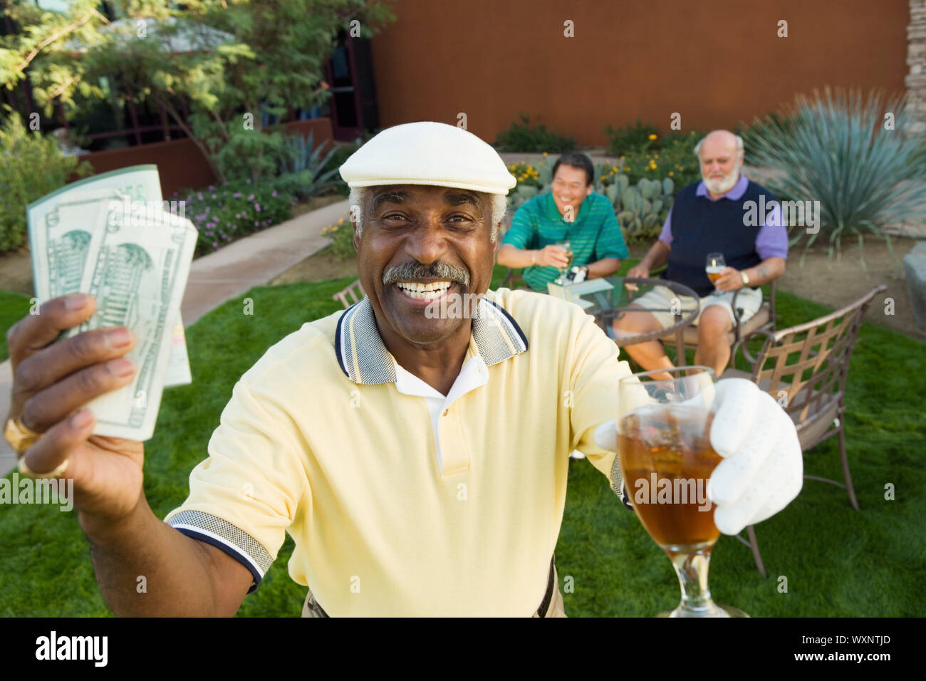 Senior Golfer Wins Friendly Wager Stock Photo - Alamy