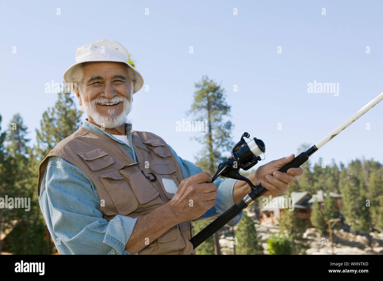 Smiling Man Fishing Stock Photo - Alamy