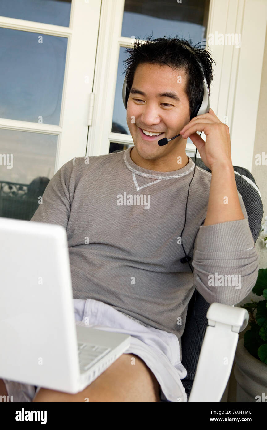 Man Web Surfing on Porch Stock Photo - Alamy