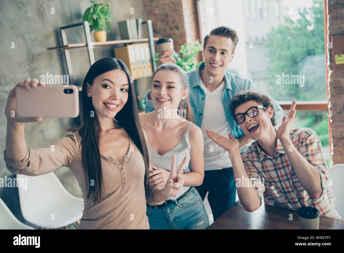 Four cheerful glad funky people, guys and girls, friends having Stock ...