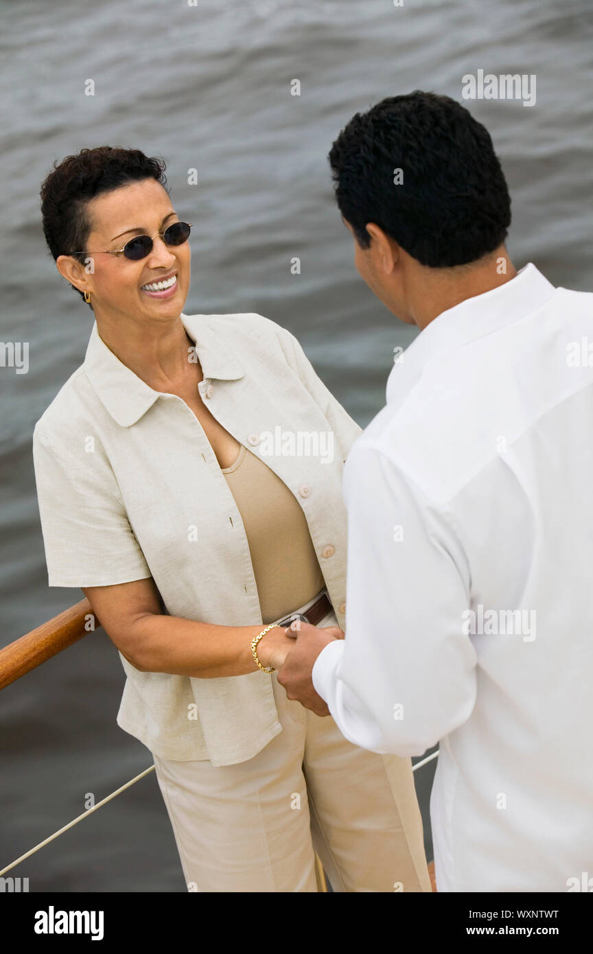 Couple Holding Hands on Boat Stock Photo - Alamy