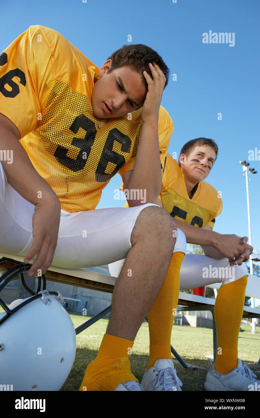 Two Football Players on the Bench Stock Photo - Alamy