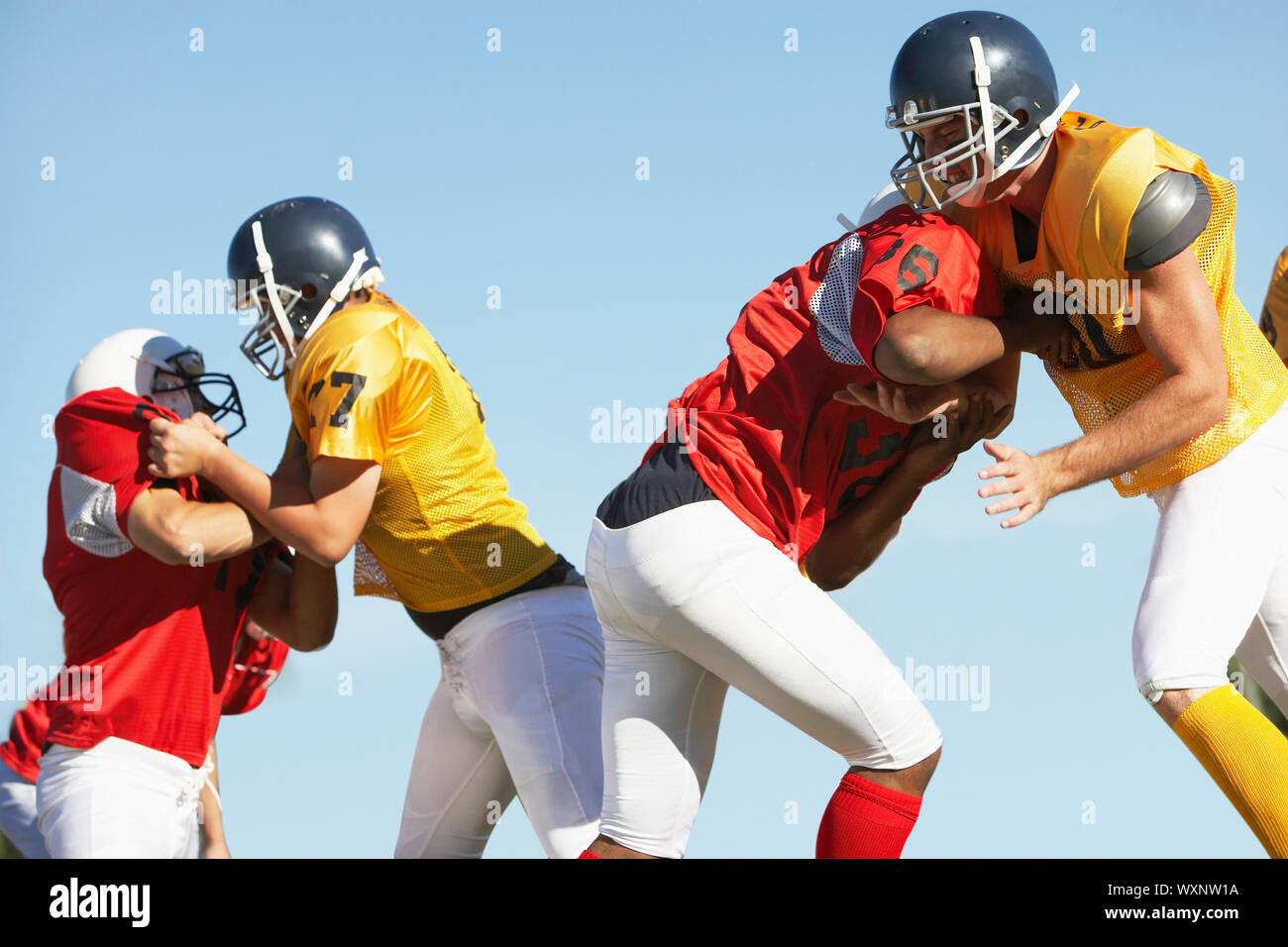Football Players Tackling Stock Photo - Alamy
