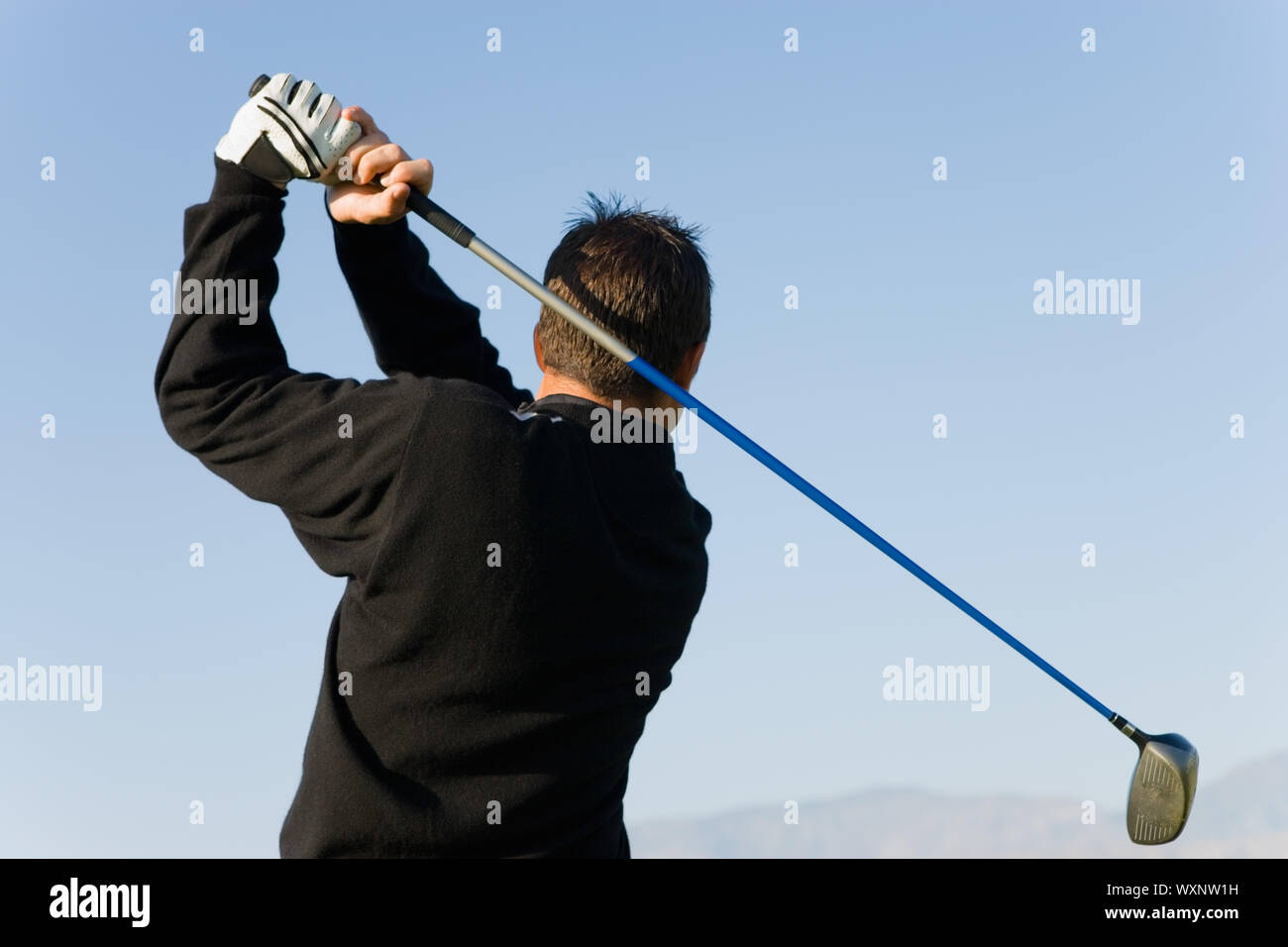Man Swinging Golf Club Stock Photo - Alamy