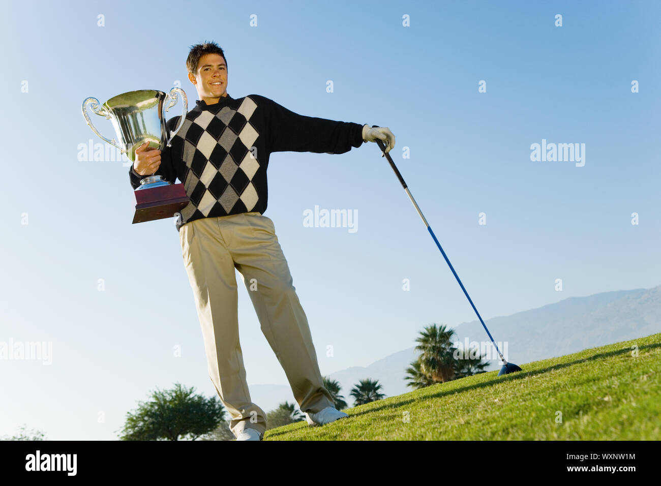 Young Man Holding Golf Trophy Stock Photo - Alamy