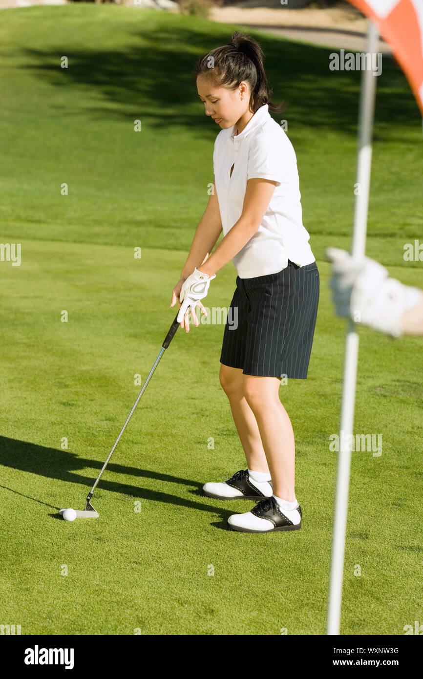 Golfer Preparing to Sink Putt Stock Photo - Alamy