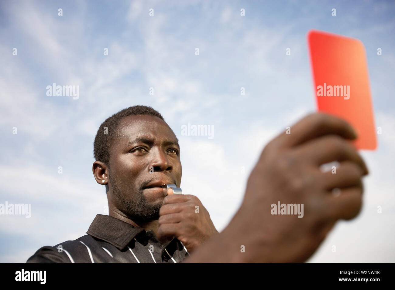 Soccer Referee Holding Out a Red Card Stock Photo - Alamy