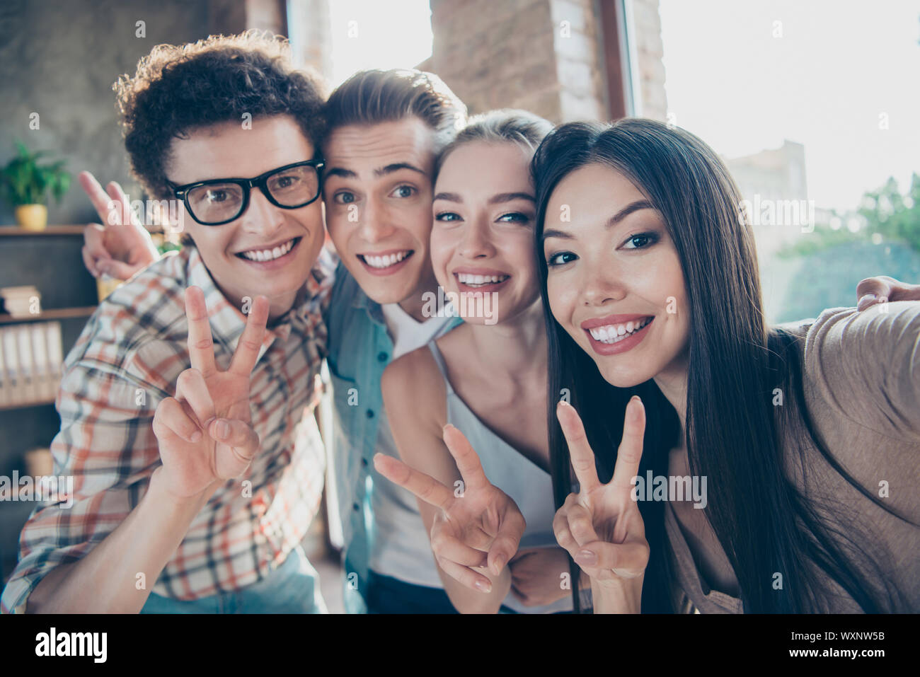 Self-portrait of four cheerful glad adorable people, handsome ne Stock ...