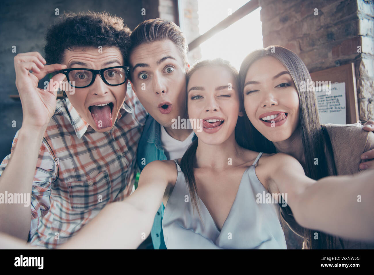 Self-portrait of four cheerful glad adorable people, handsome ne Stock ...