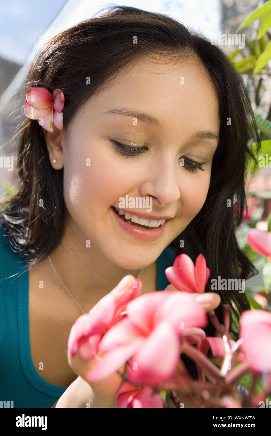 Beautiful Young Woman Smelling Flowers Stock Photo - Alamy