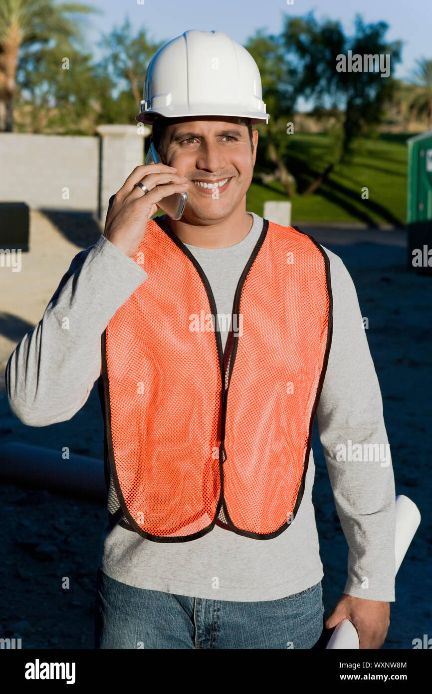 Construction Worker Using Cell Phone Stock Photo - Alamy