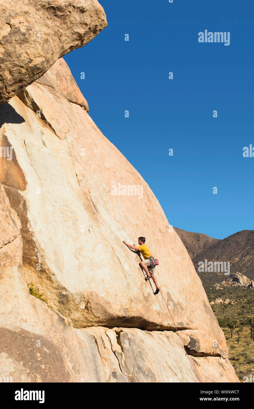 Man Climbing on Cliff Stock Photo - Alamy