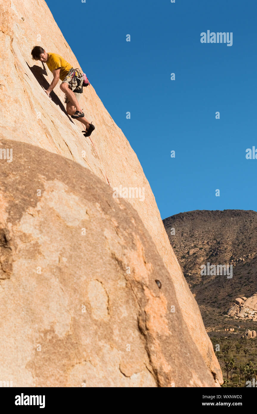 Man Climbing on Cliff Stock Photo - Alamy