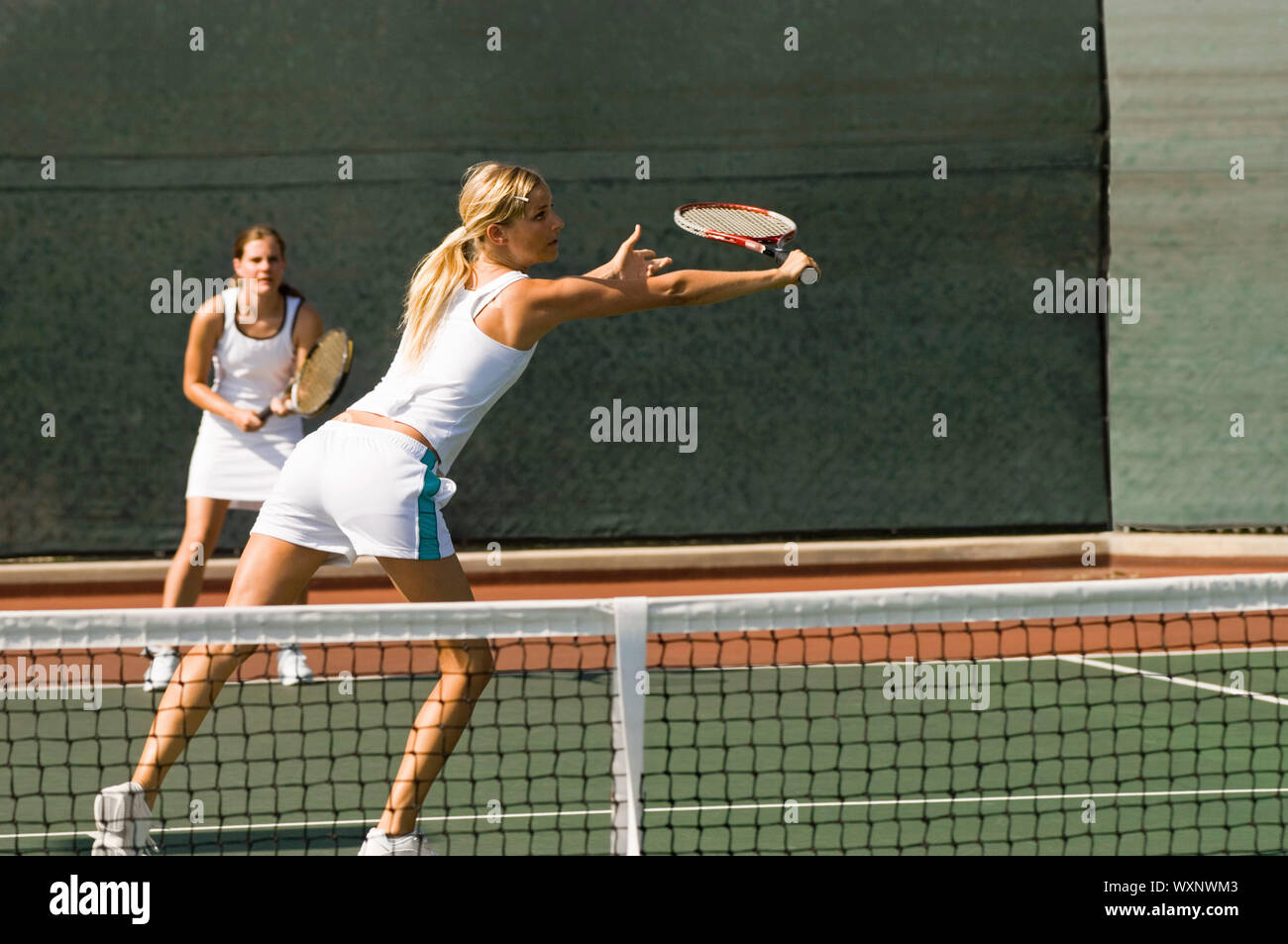 Tennis Player Reaching For Ball Stock Photo - Alamy