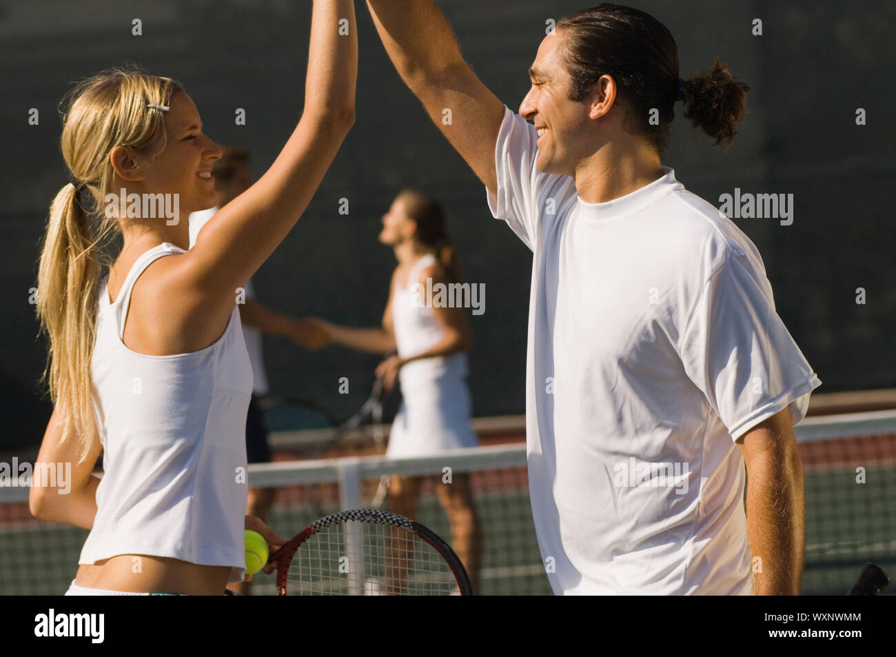 Mixed Doubles Partners High-Fiving Each Other Stock Photo - Alamy