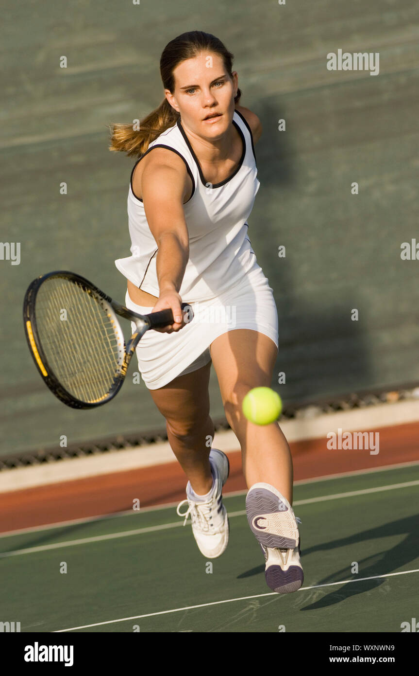 Tennis Player Reaching For Ball Stock Photo - Alamy