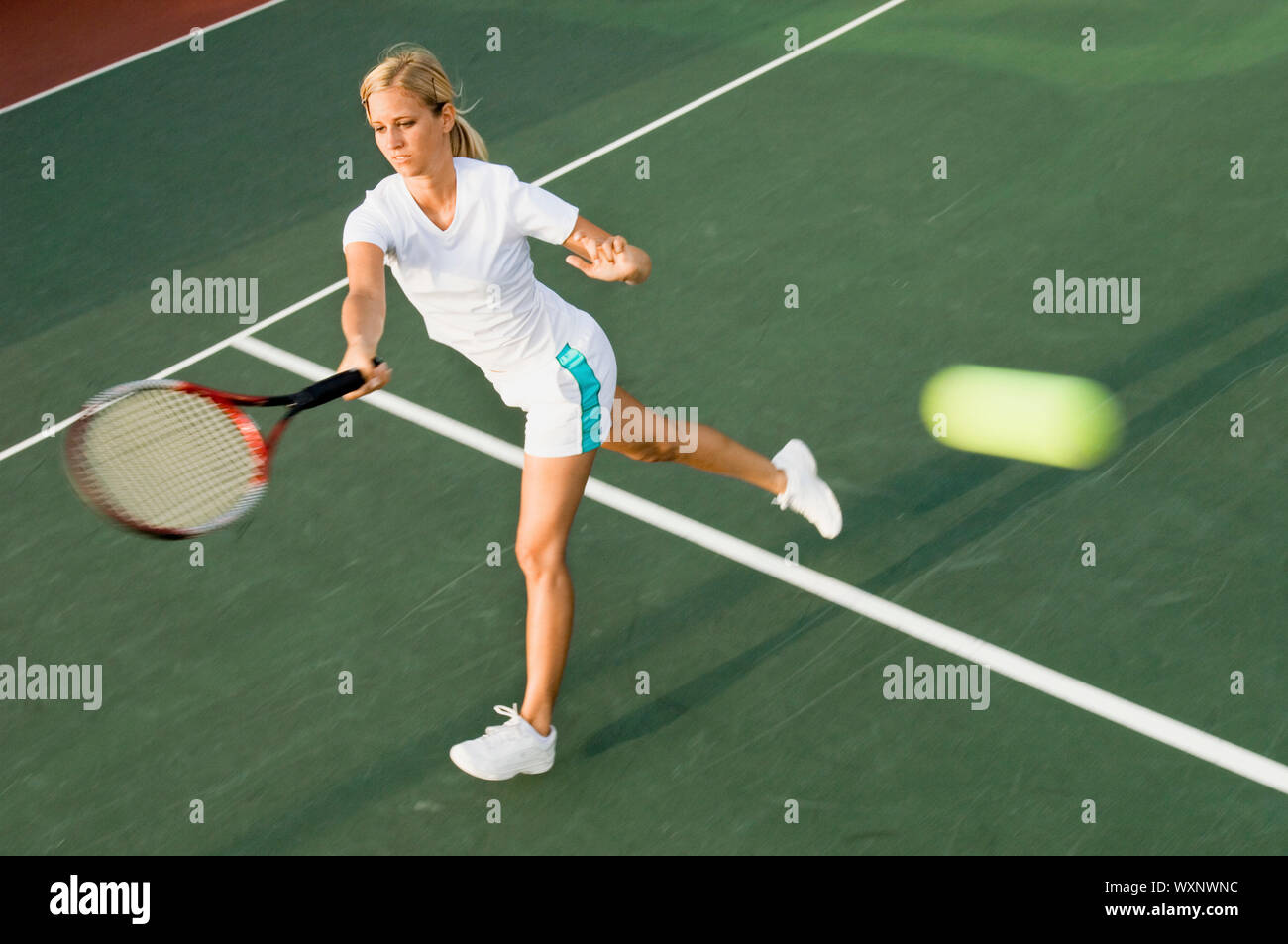 Tennis Player Swinging at Ball Stock Photo - Alamy