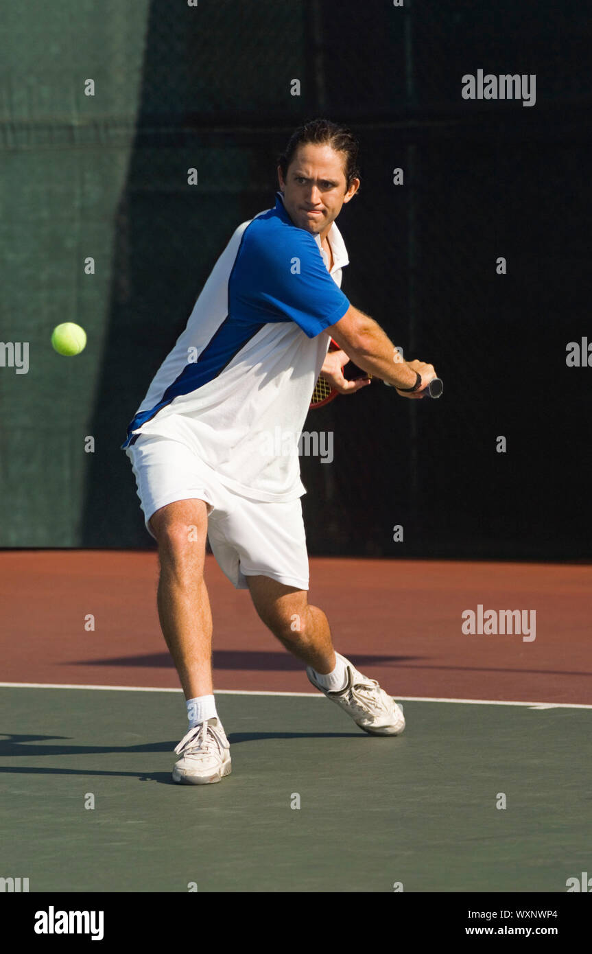 Tennis Player Hitting Backhand Stock Photo - Alamy