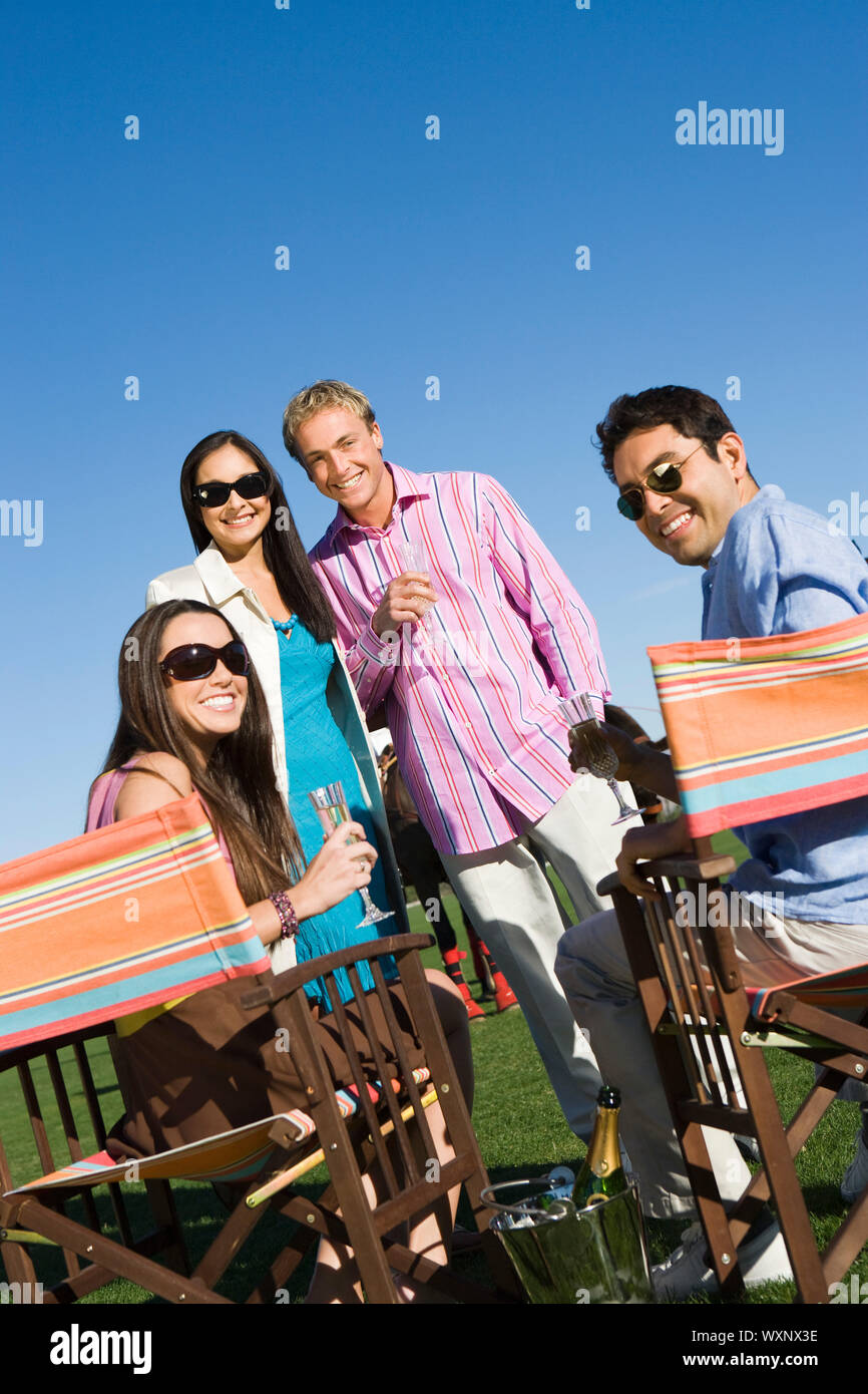 Four friends toasting on polo field, portrait Stock Photo - Alamy