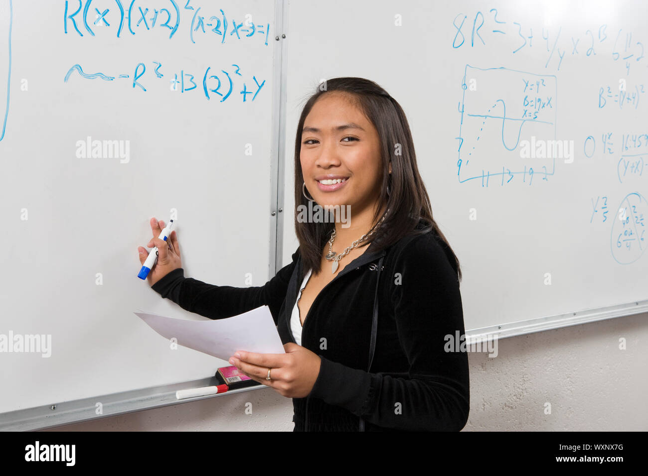 Female student writing maths equations on whiteboard Stock Photo - Alamy