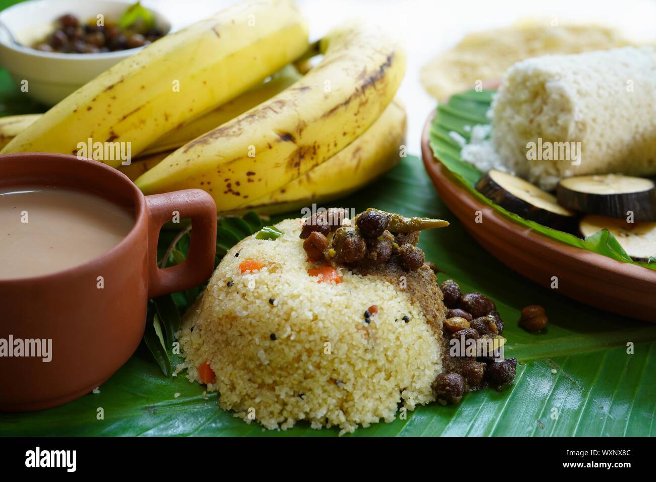 South Indian breakfast Rava Upma, Kerala Puttu, banana and Tea Stock ...