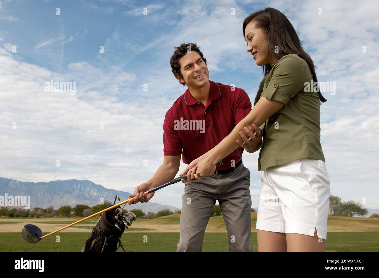 Woman Getting a Golf Lesson Stock Photo - Alamy