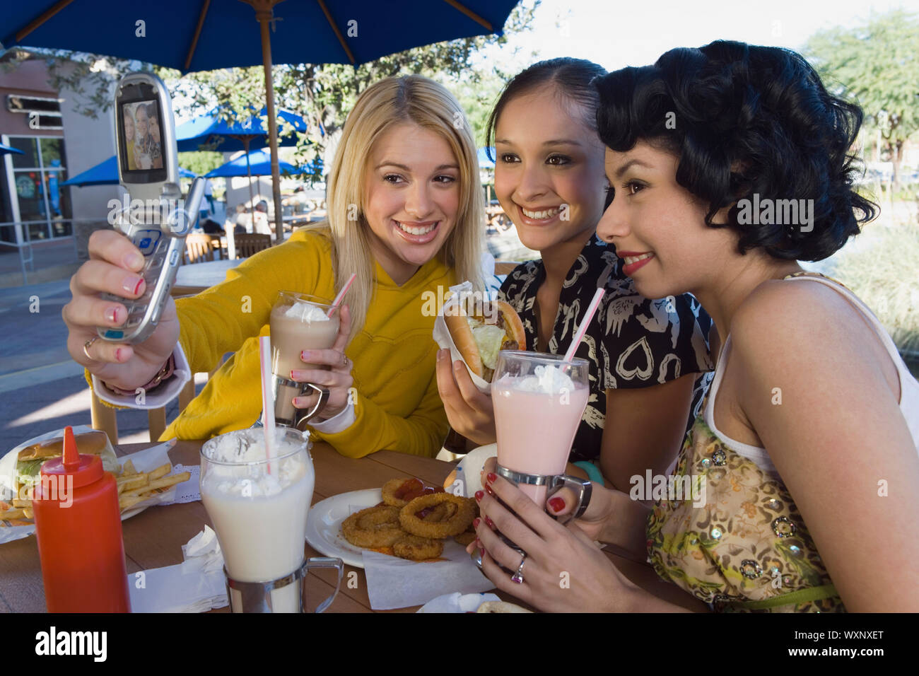 Friends Drinking Milkshakes and Posing for Photo Stock Photo - Alamy