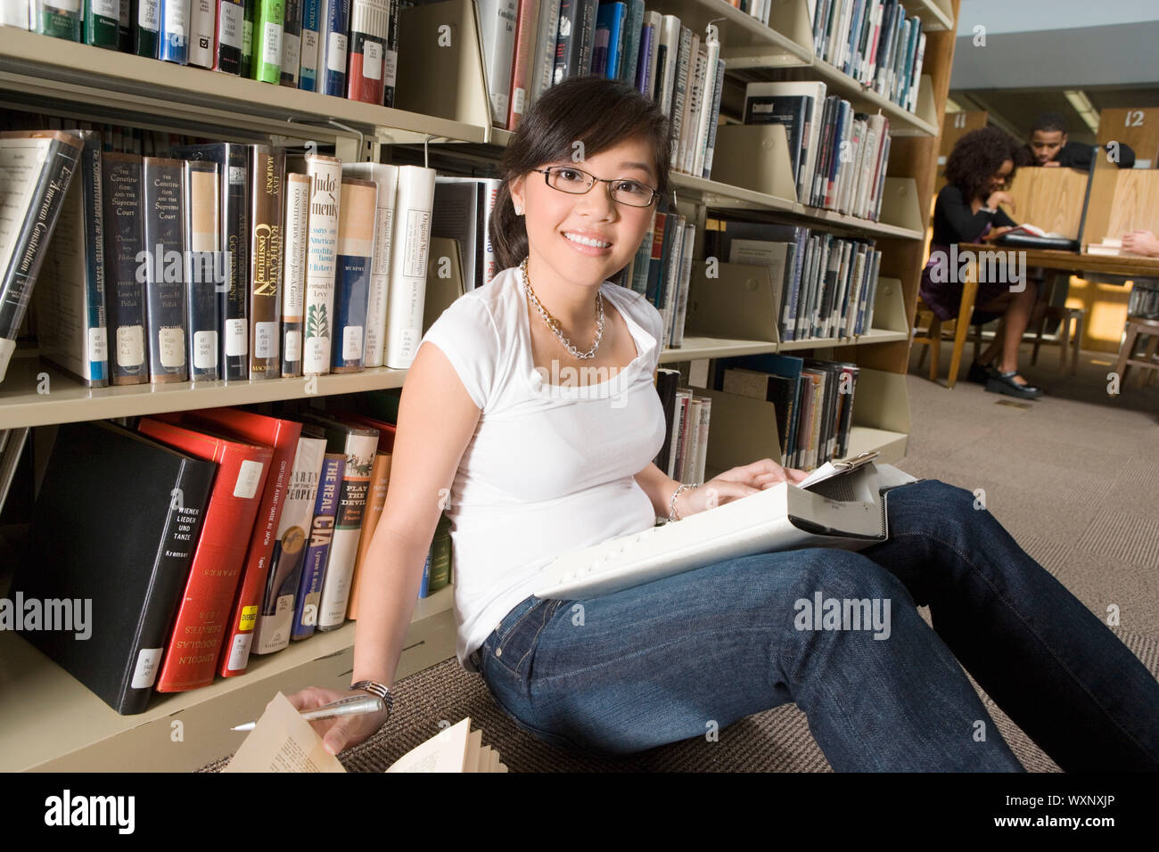 Student Taking Notes in the Library Stock Photo - Alamy