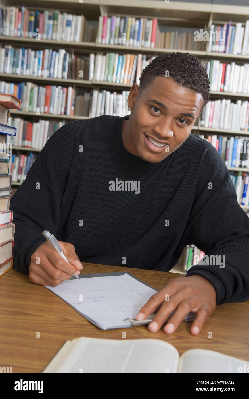 College Student Taking Notes in the Library Stock Photo - Alamy