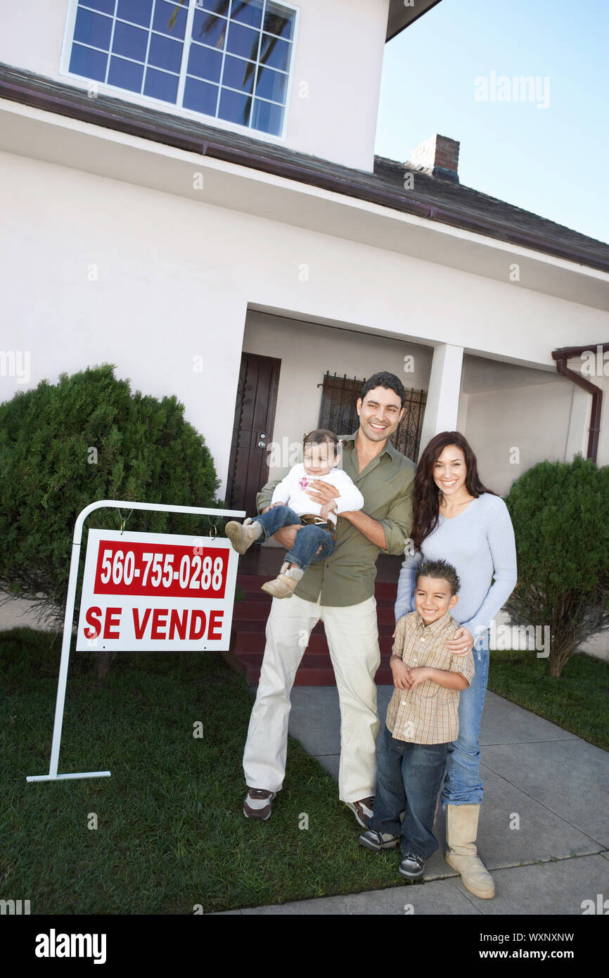 Happy Homeowners with Sign Stock Photo - Alamy