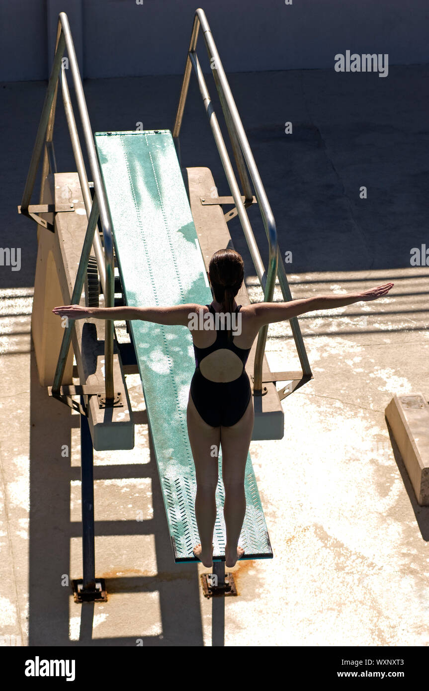 Female swimmer standing on diving board Stock Photo - Alamy