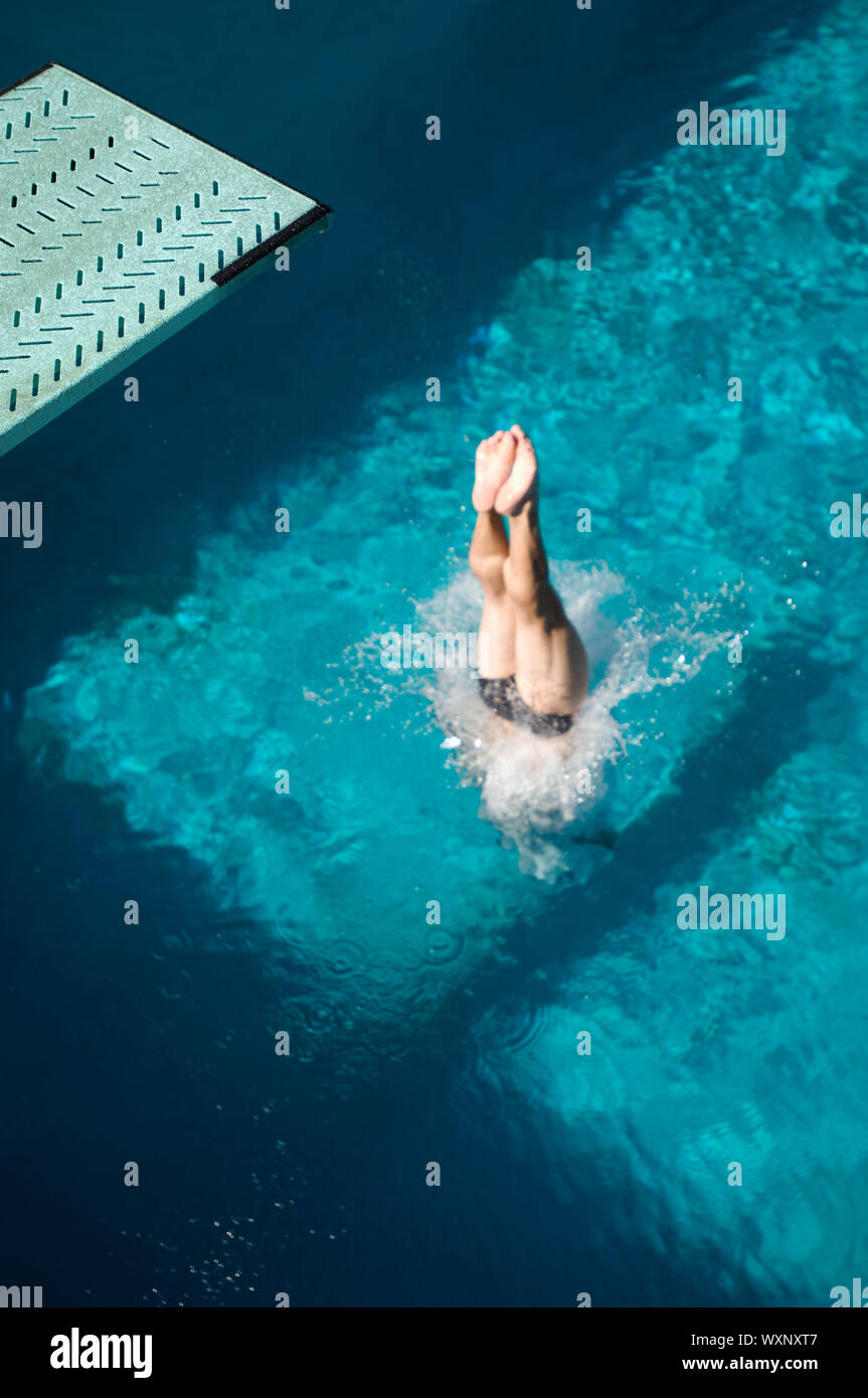 Swimmer diving into swimming pool Stock Photo - Alamy