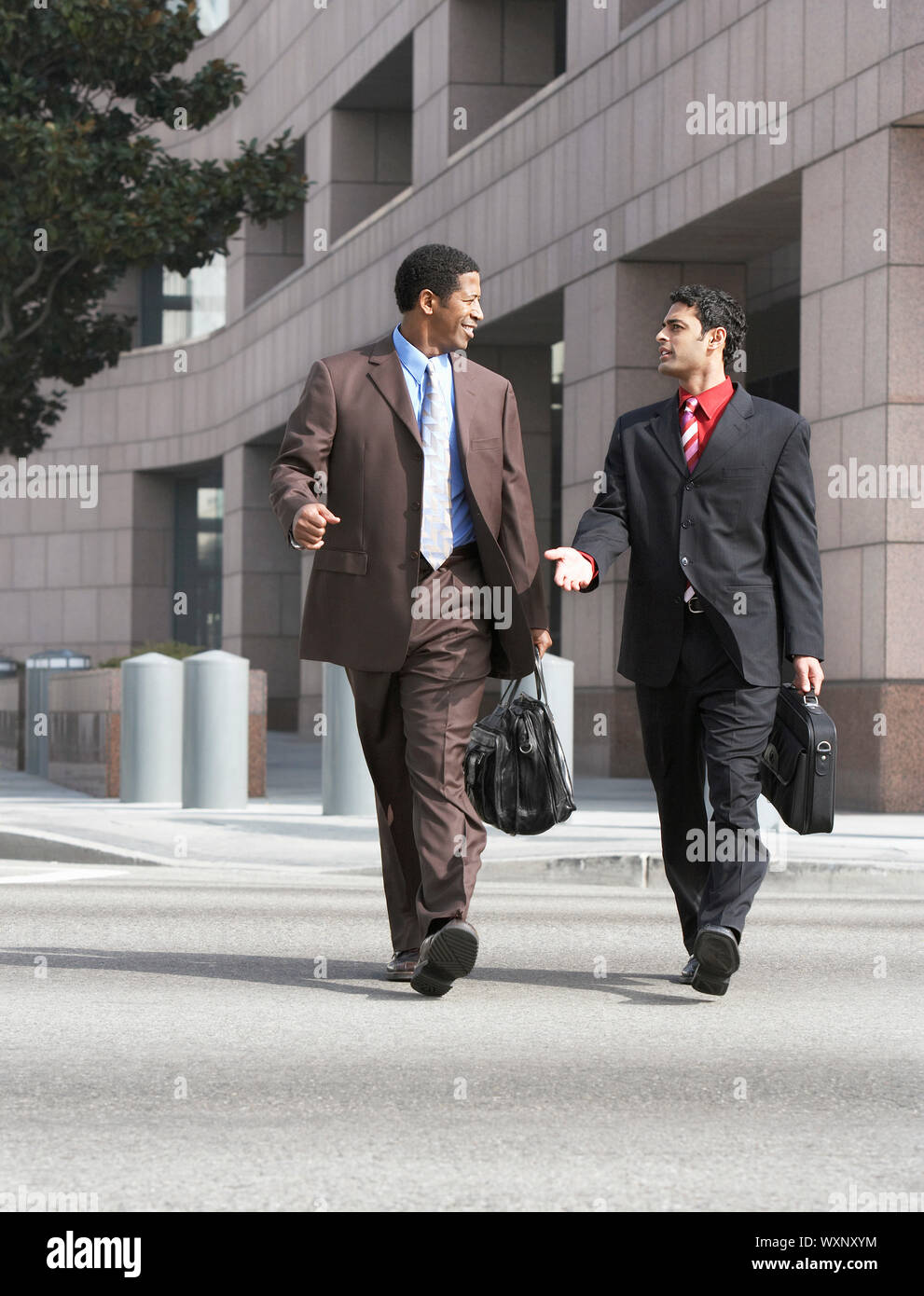 Two Businessmen Walking Stock Photo - Alamy
