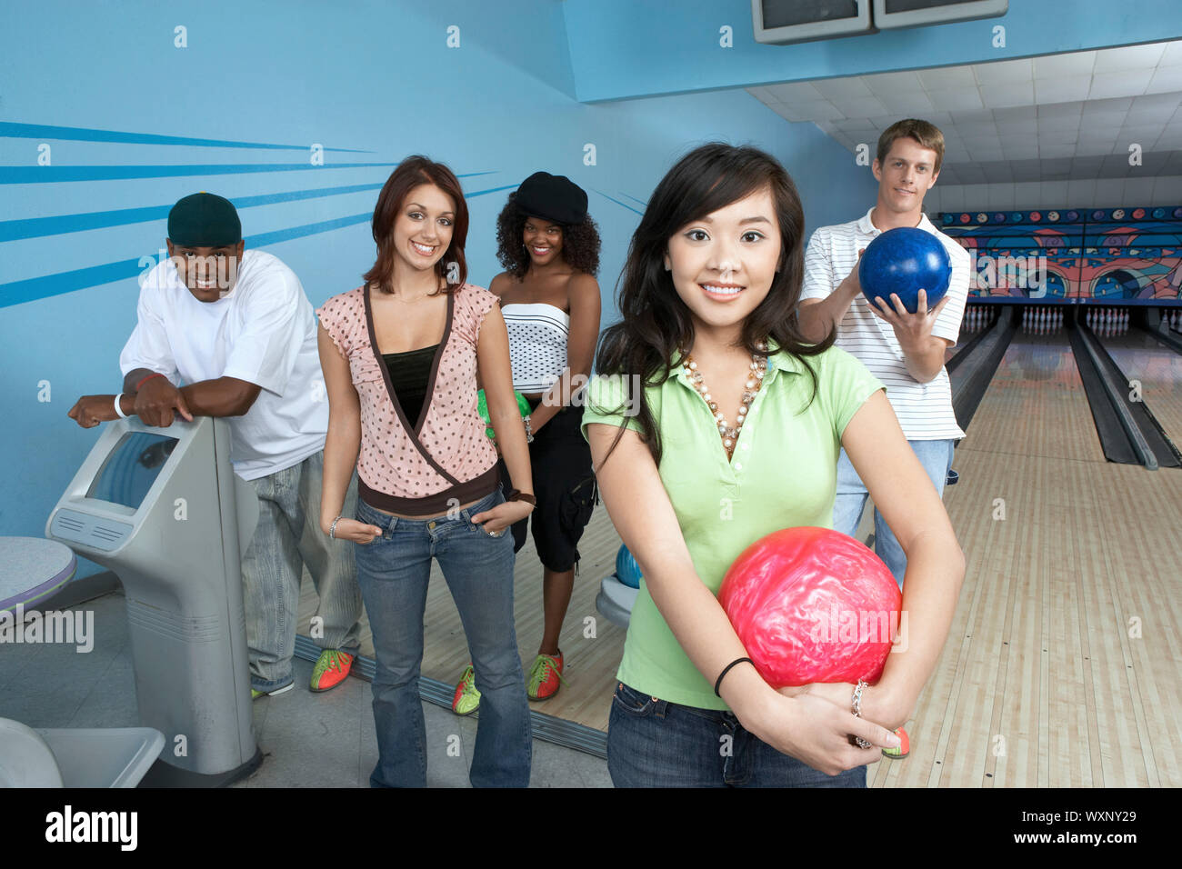 Group of Friends in Bowling Alley Stock Photo - Alamy