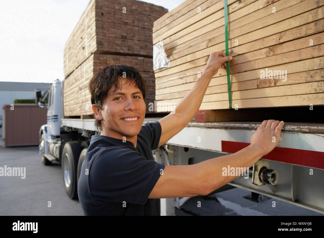 Young Man Checking Load on Truck Trailer Stock Photo - Alamy