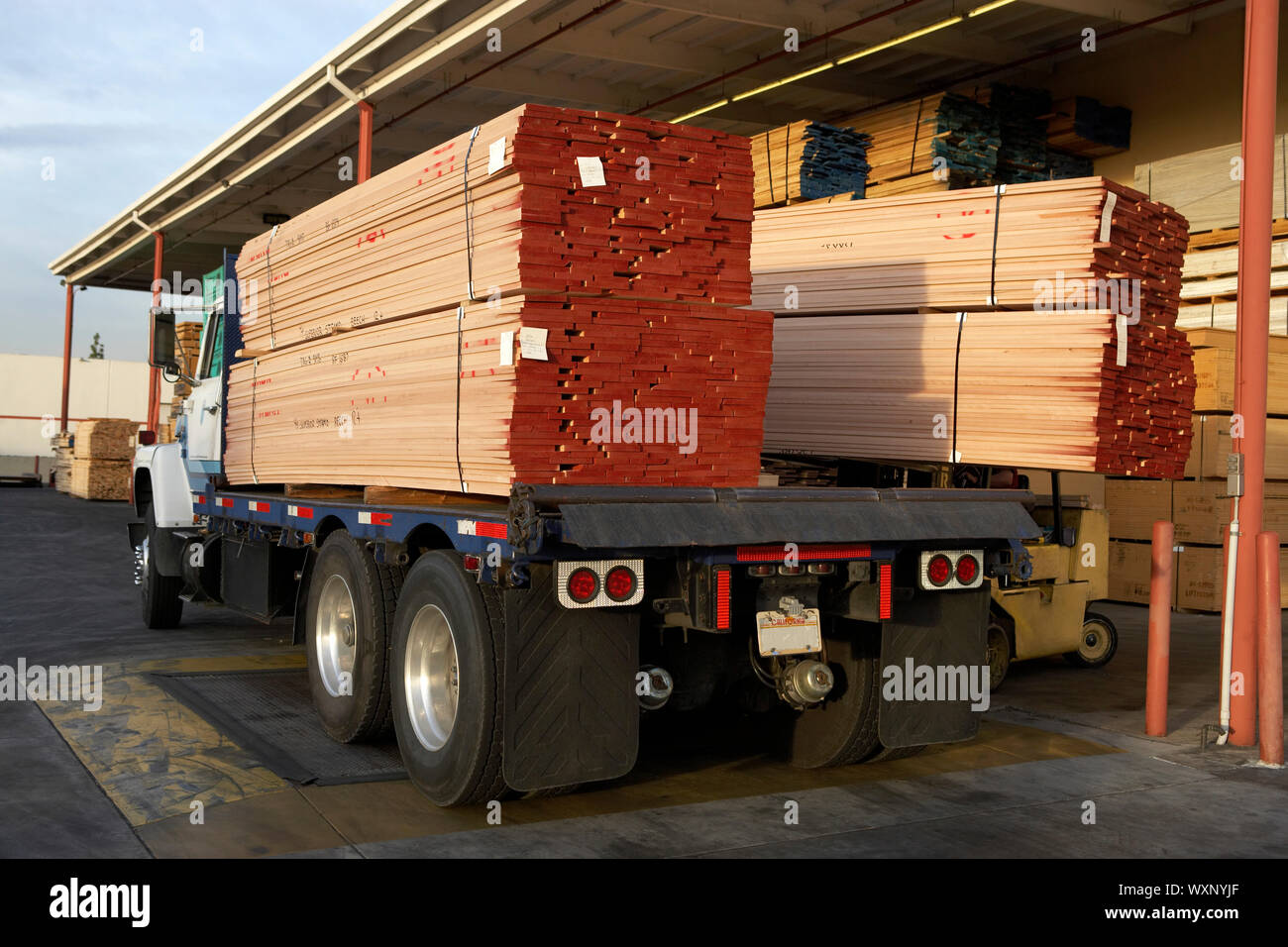 Stacks of Lumber Being Loaded onto Truck at Loading Dock Stock Photo ...