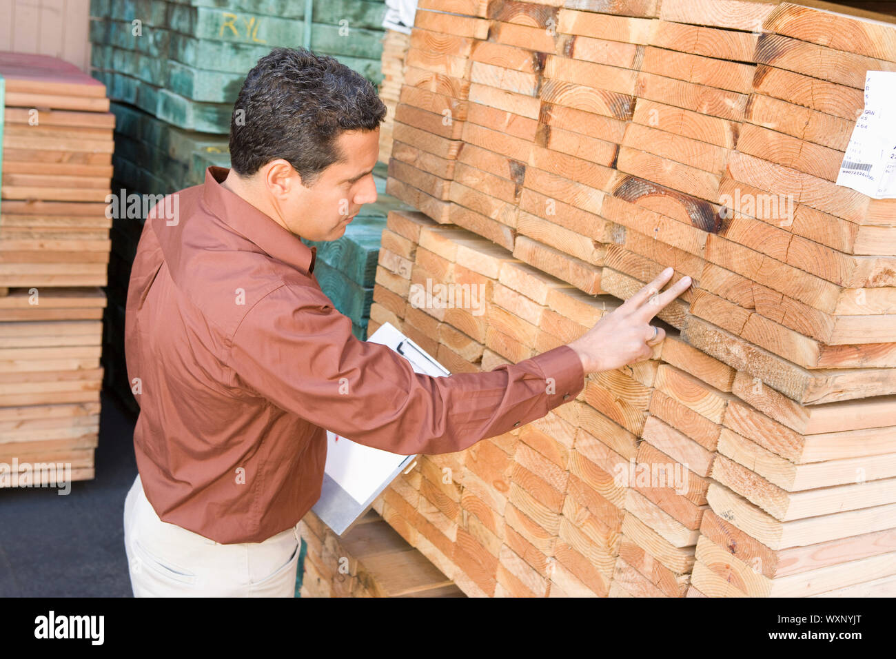 Mid-adult man stock-taking in warehouse Stock Photo - Alamy