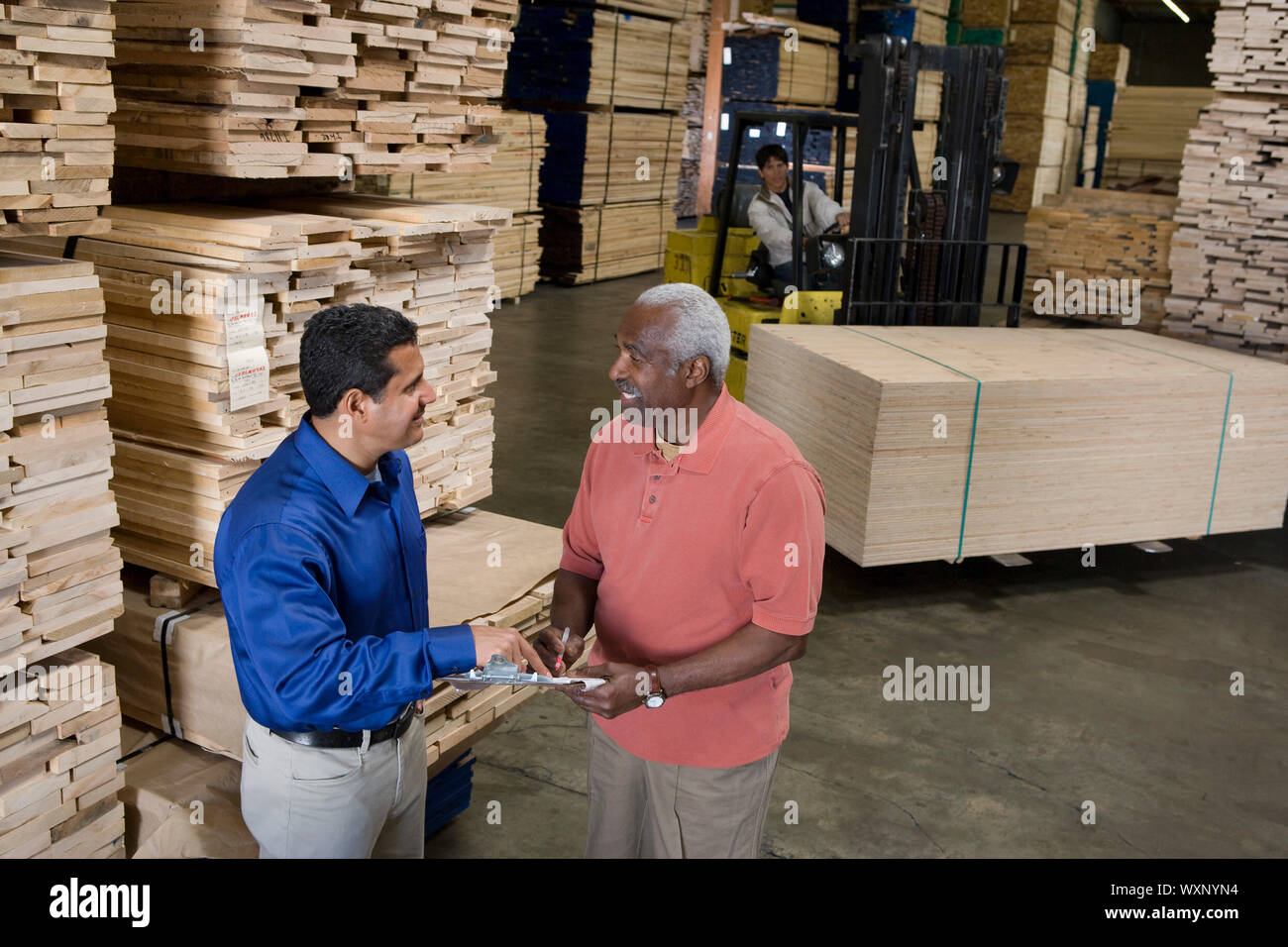 Men stock-taking in warehouse Stock Photo - Alamy